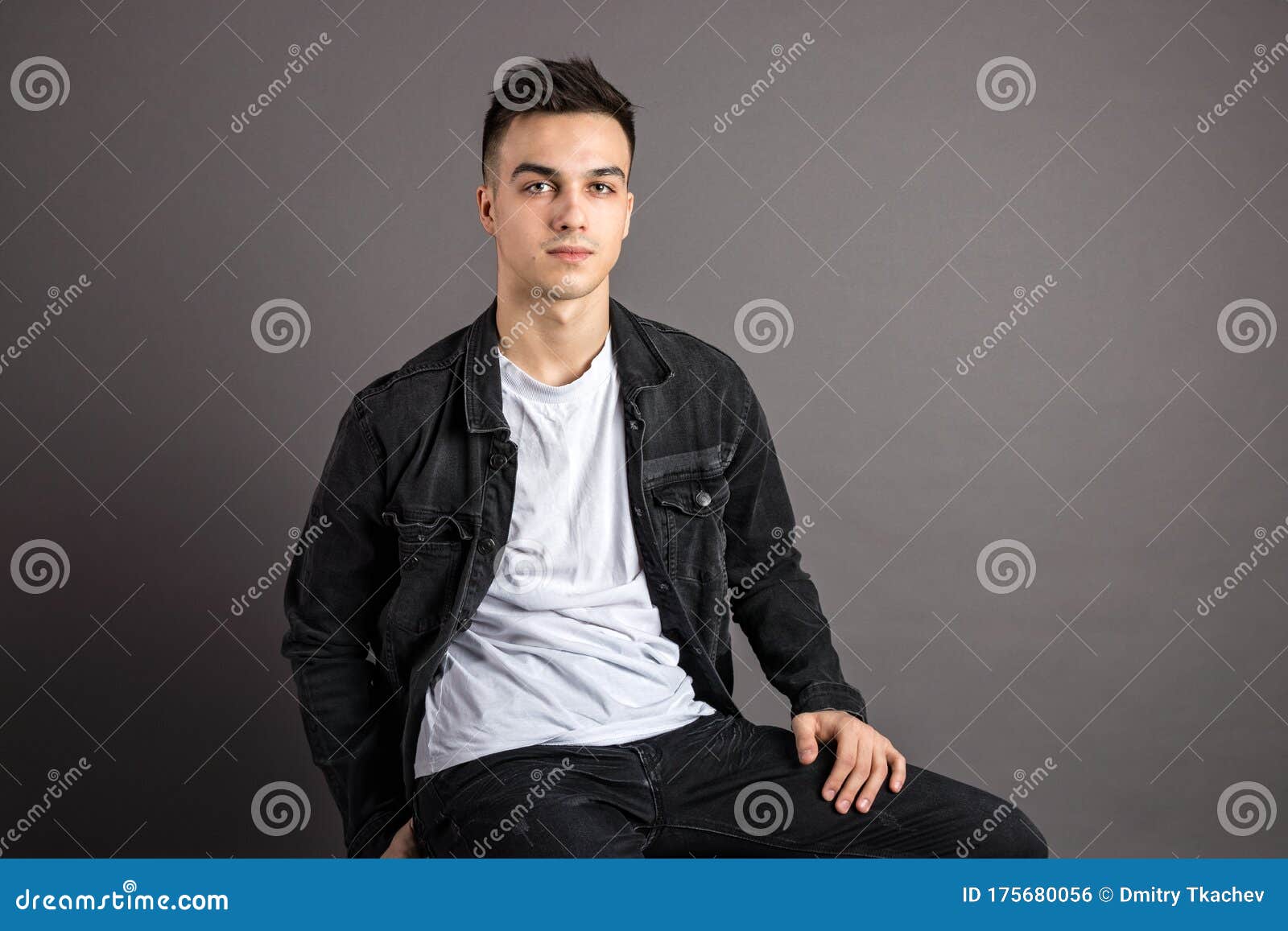 Young Serious Man Posing in Studio. Gray Background Stock Photo - Image ...