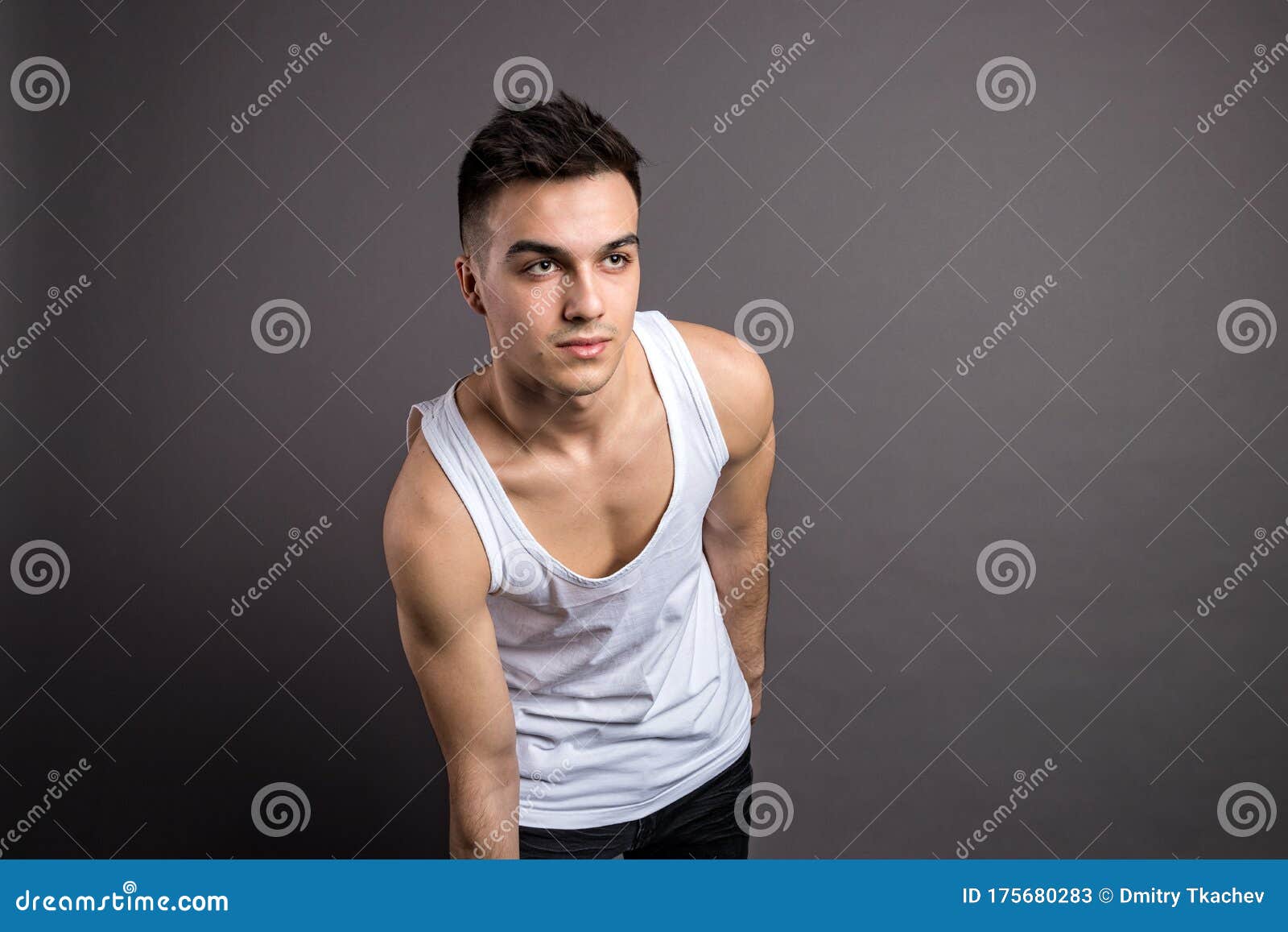 Young Serious Man Posing in Studio. Gray Background Stock Image - Image ...