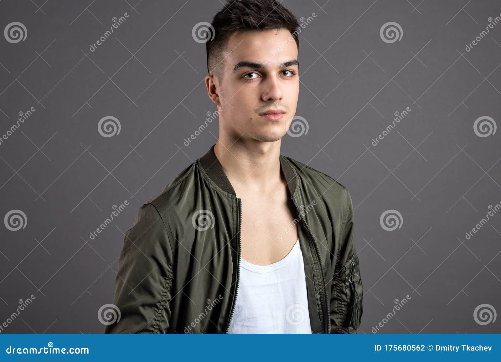 Young Serious Man Posing in Studio. Gray Background Stock Photo - Image ...