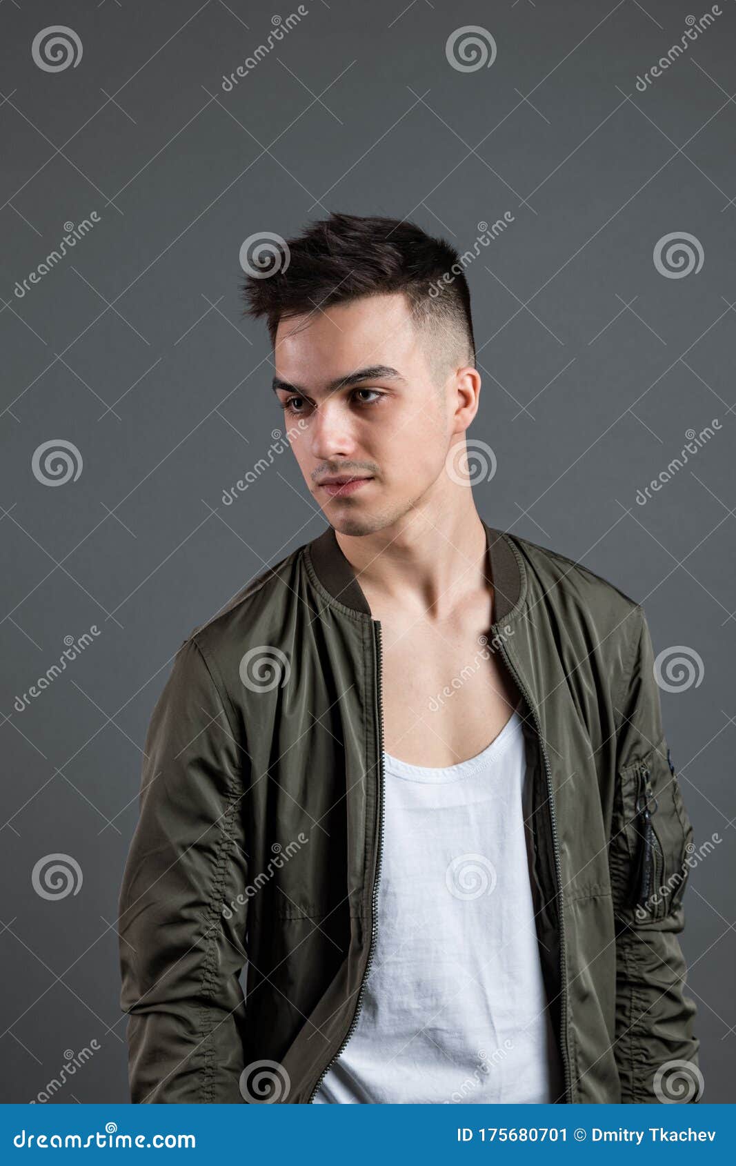 Young Serious Man Posing in Studio. Gray Background Stock Image - Image ...