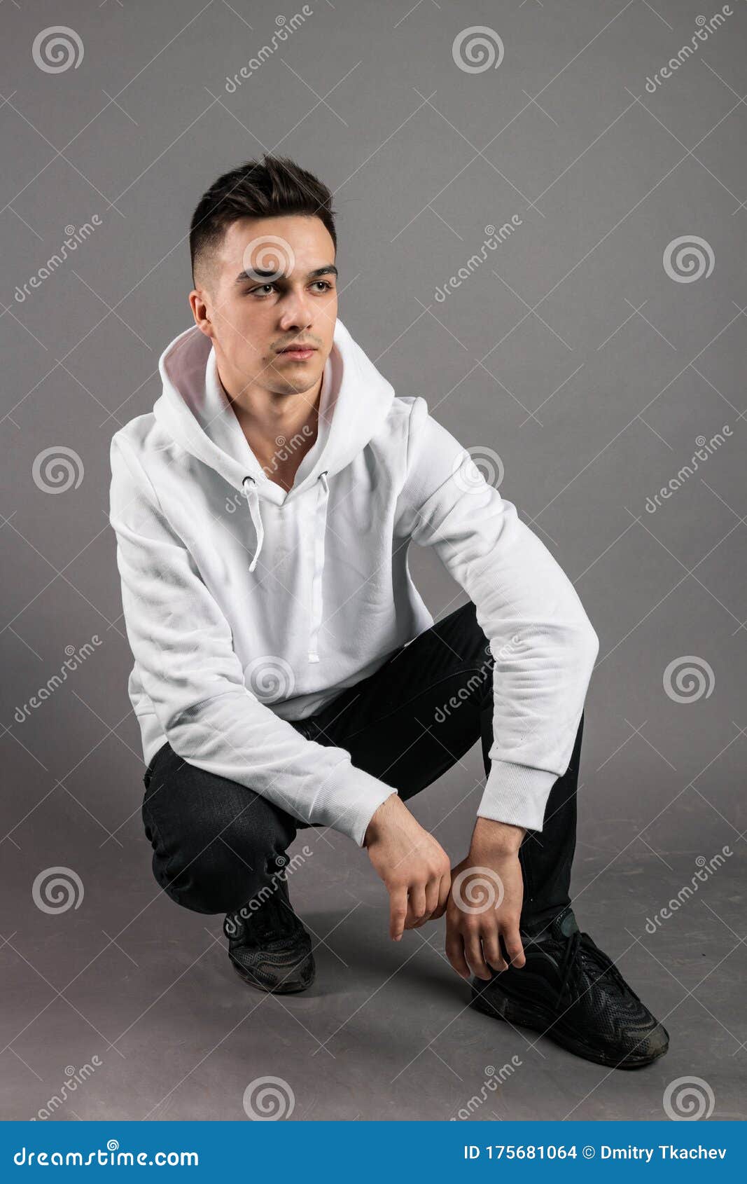 Young Serious Man Posing in Studio. Gray Background Stock Photo - Image ...