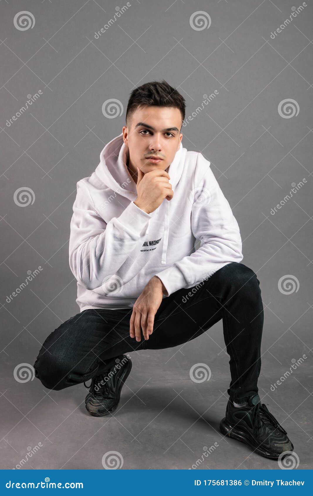 Young Serious Man Posing in Studio. Gray Background Stock Photo - Image ...
