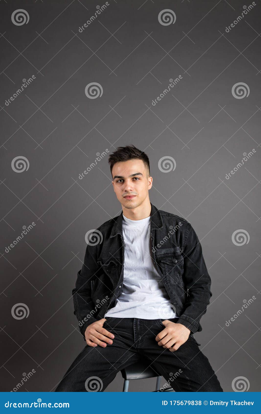 Young Serious Man Posing in Studio. Gray Background Stock Photo - Image ...