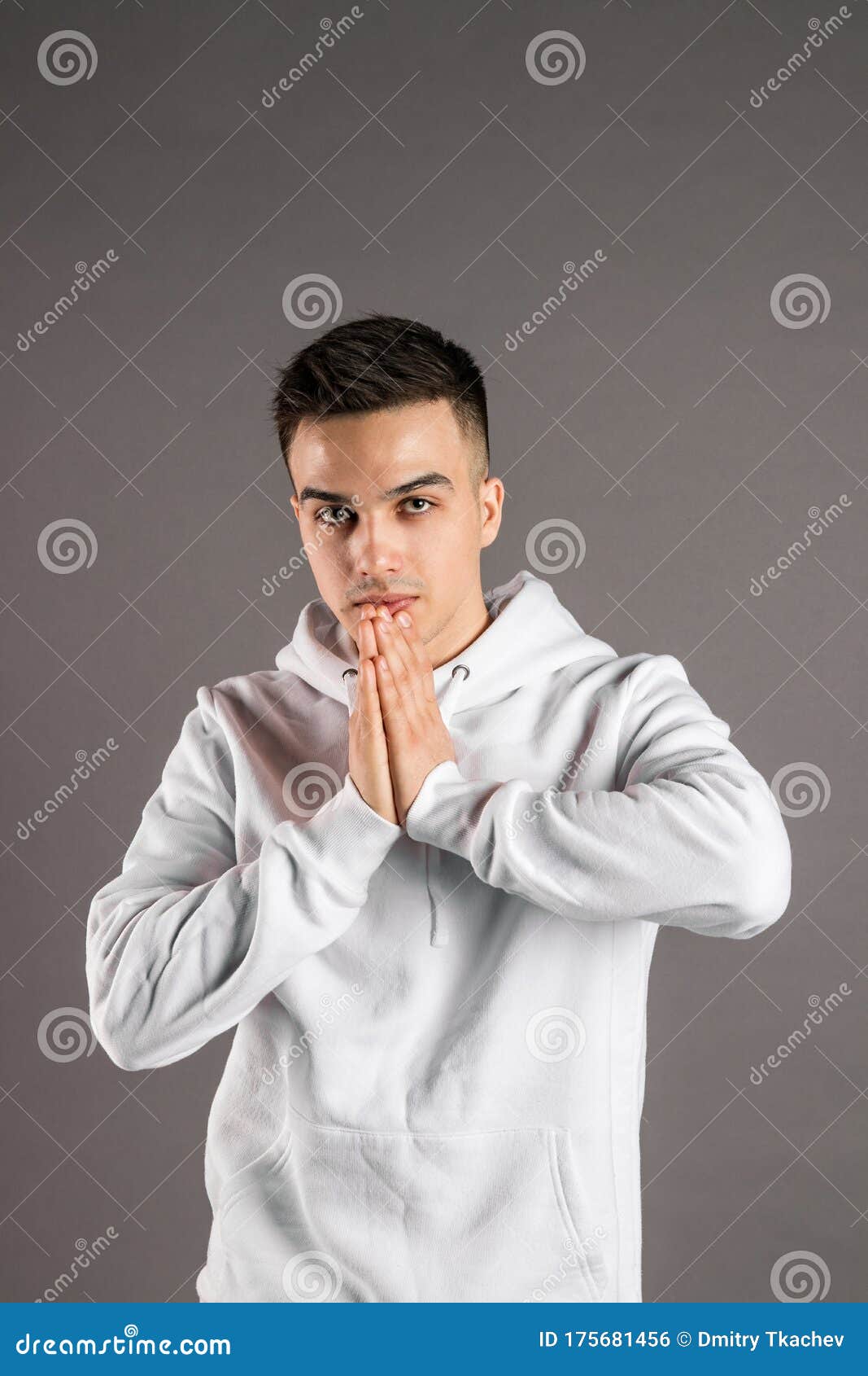 Young Serious Man Posing in Studio. Gray Background Stock Photo - Image ...