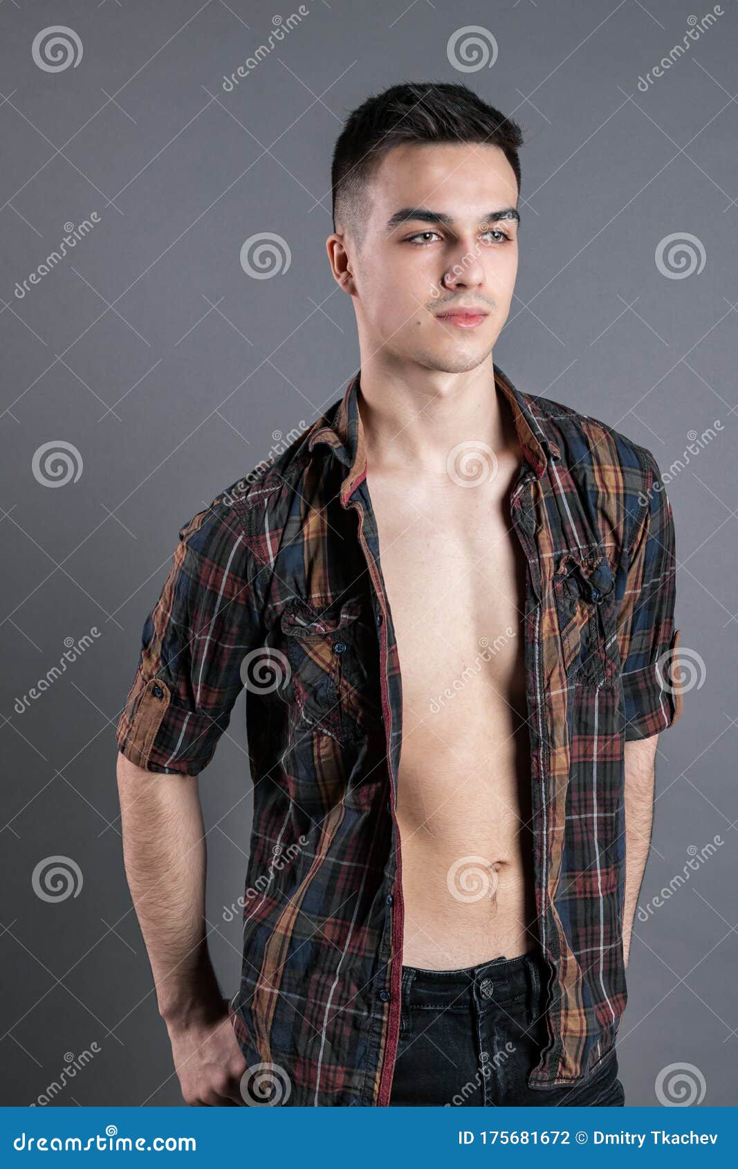 Young Serious Man Posing in Studio. Gray Background Stock Photo - Image ...