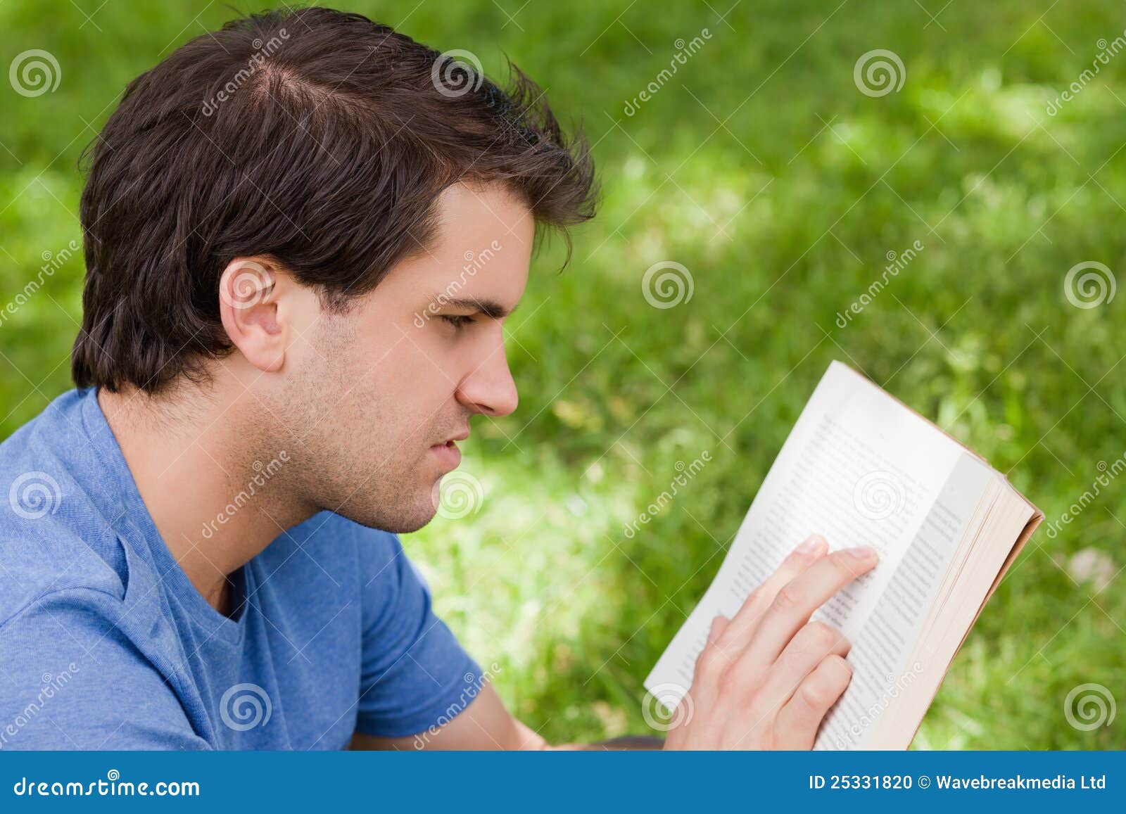Young Serious Man Reading a Book Stock Photo - Image of outdoors ...