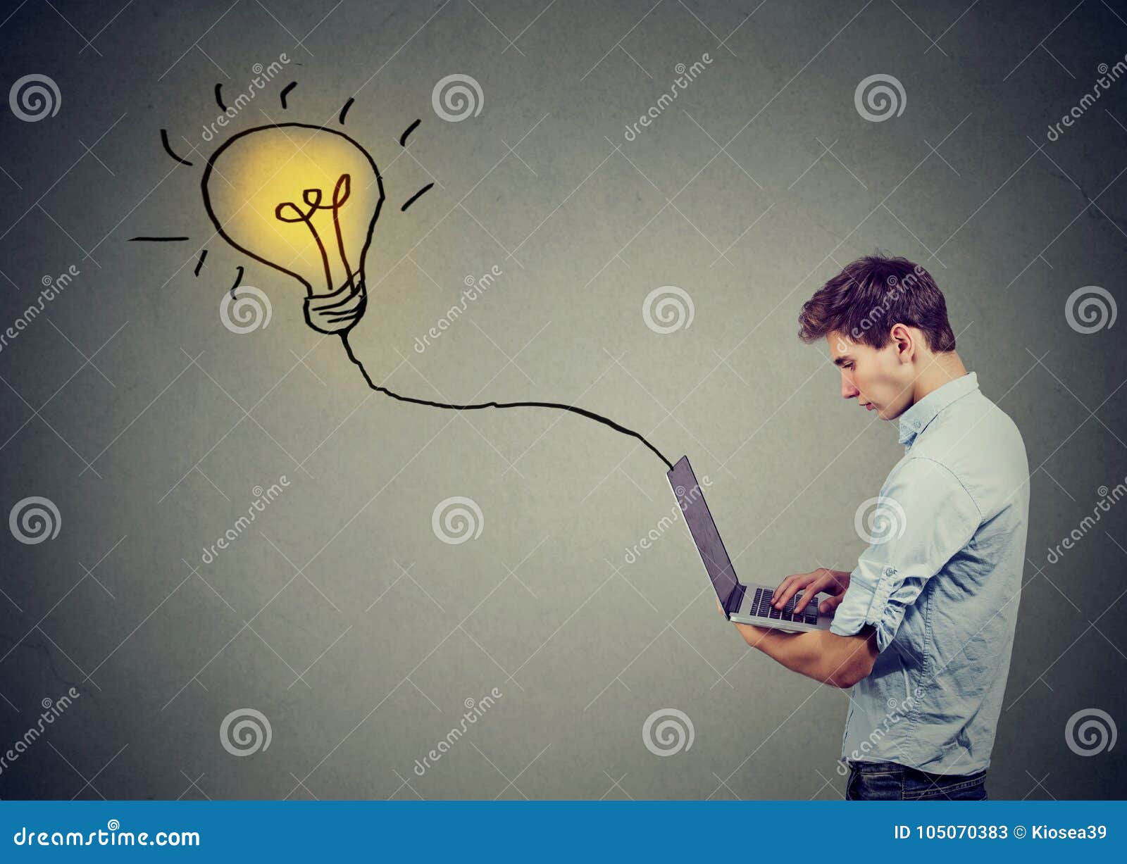 Young Serious Man Using a Laptop with Light Bulb Plugged in it Stock ...