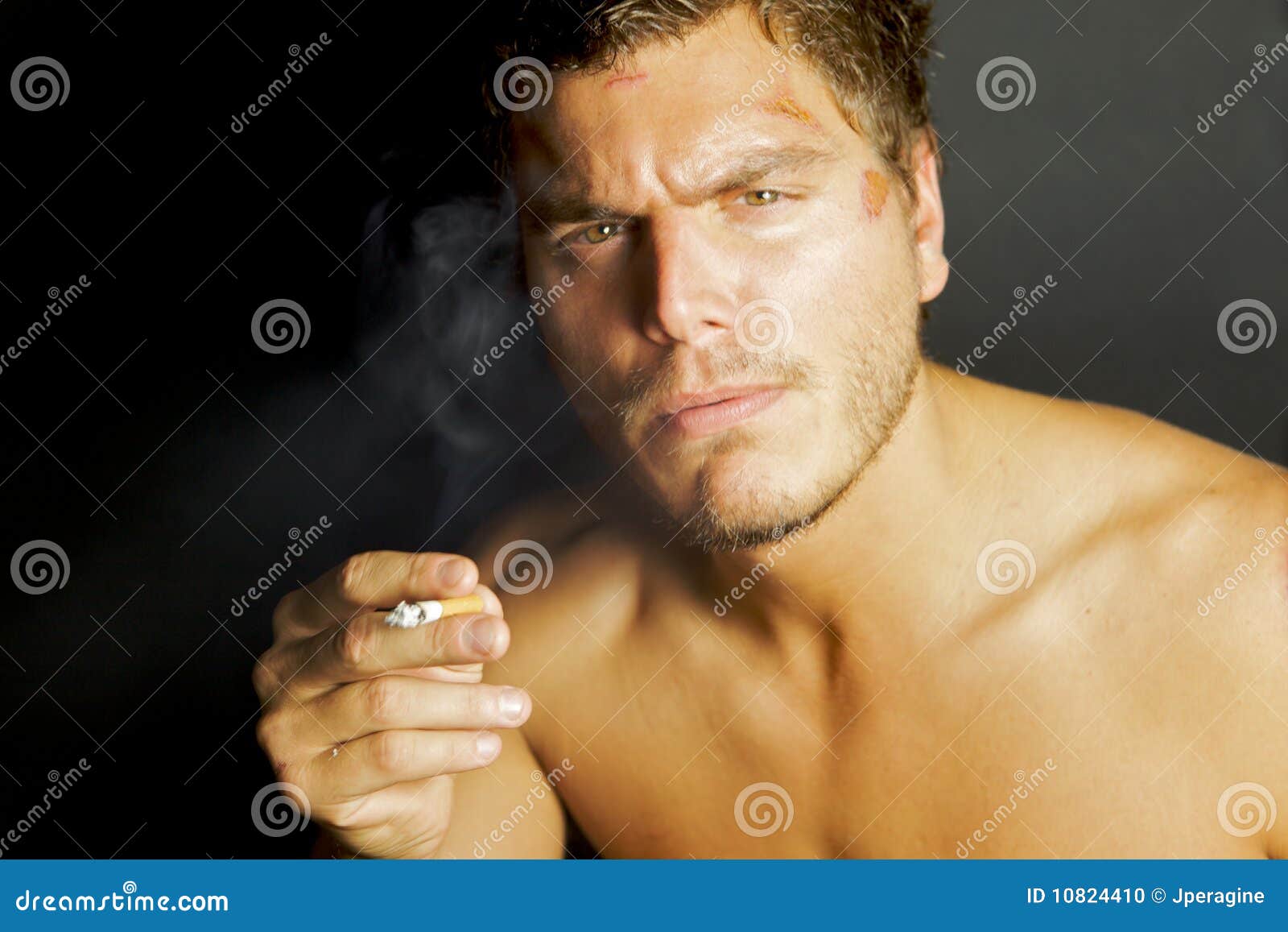 Young Man Smoking a Cigarette Stock Photo - Image of addict, hair: 10824410
