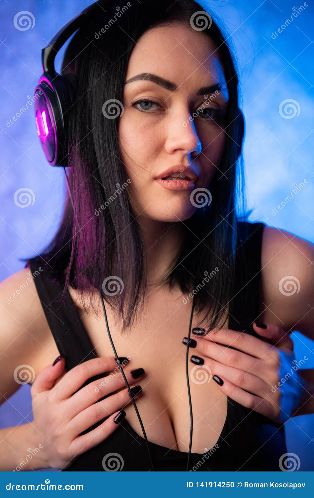 Young Woman Or Girl Dj With Dark Hair On Pretty Serious Face In Black