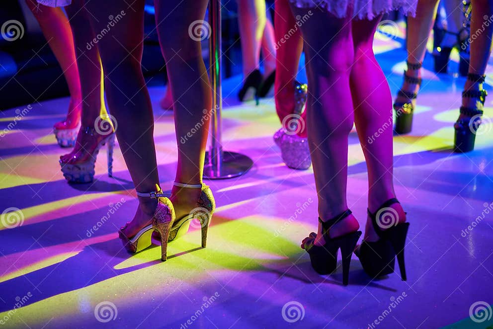 Young Woman Pole Dancing Striptease With Pylon In Night Club Beautiful