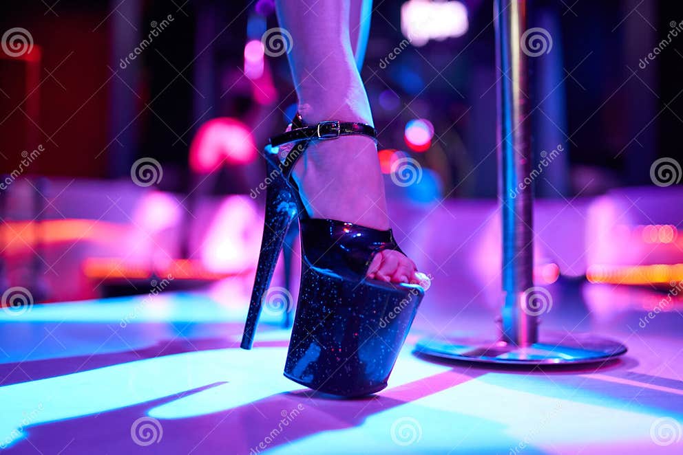 Young Woman Pole Dancing Striptease With Pylon In Night Club Beautiful