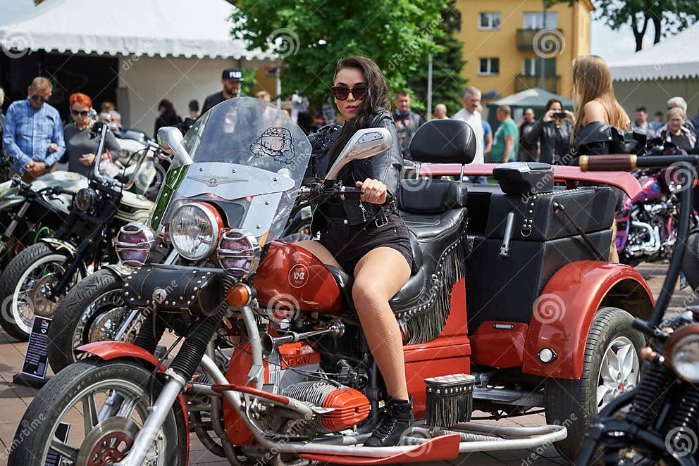 Young Woman Sitting On A Motorcycle Beautiful Girl Poses On A