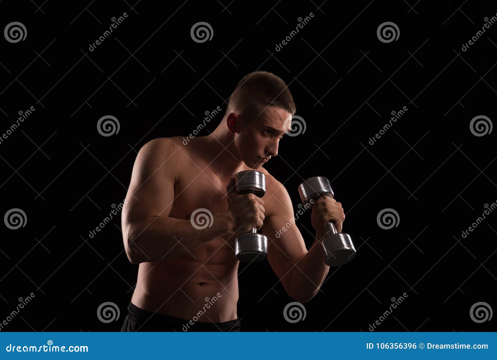 Young Fighter with Strong Hands Exercise with Weights on Black ...