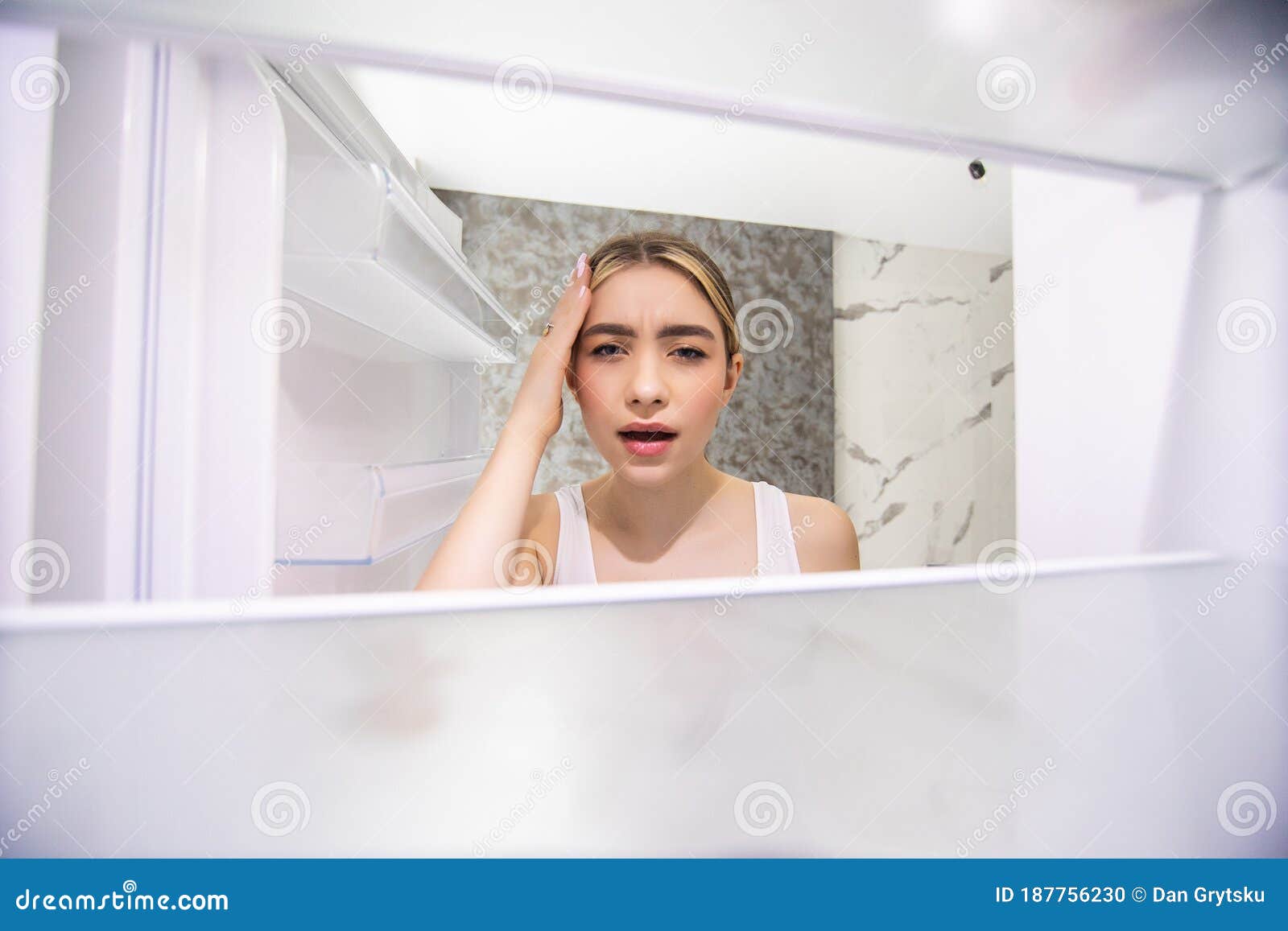 Young Shocked Woman Looking in Empty Fridge at Home Stock Photo - Image ...