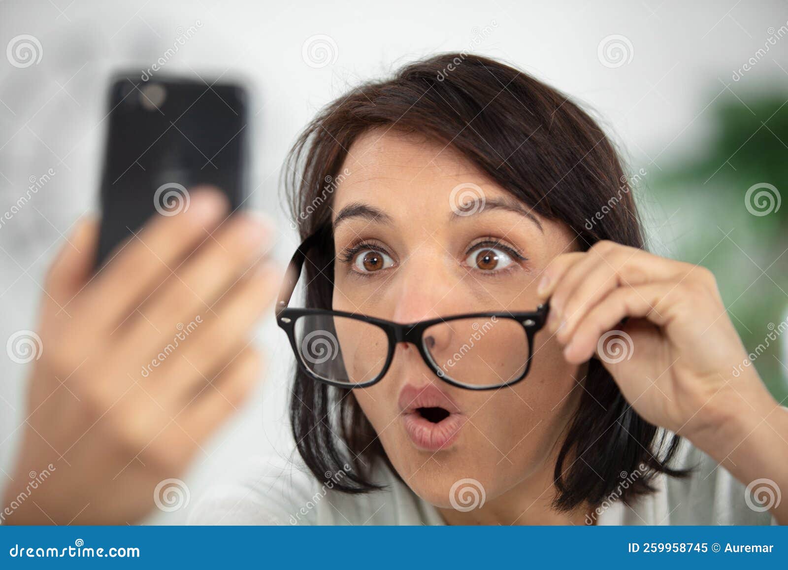 Young Shocked Woman Looking at Mobile Phone Screen Stock Image - Image ...