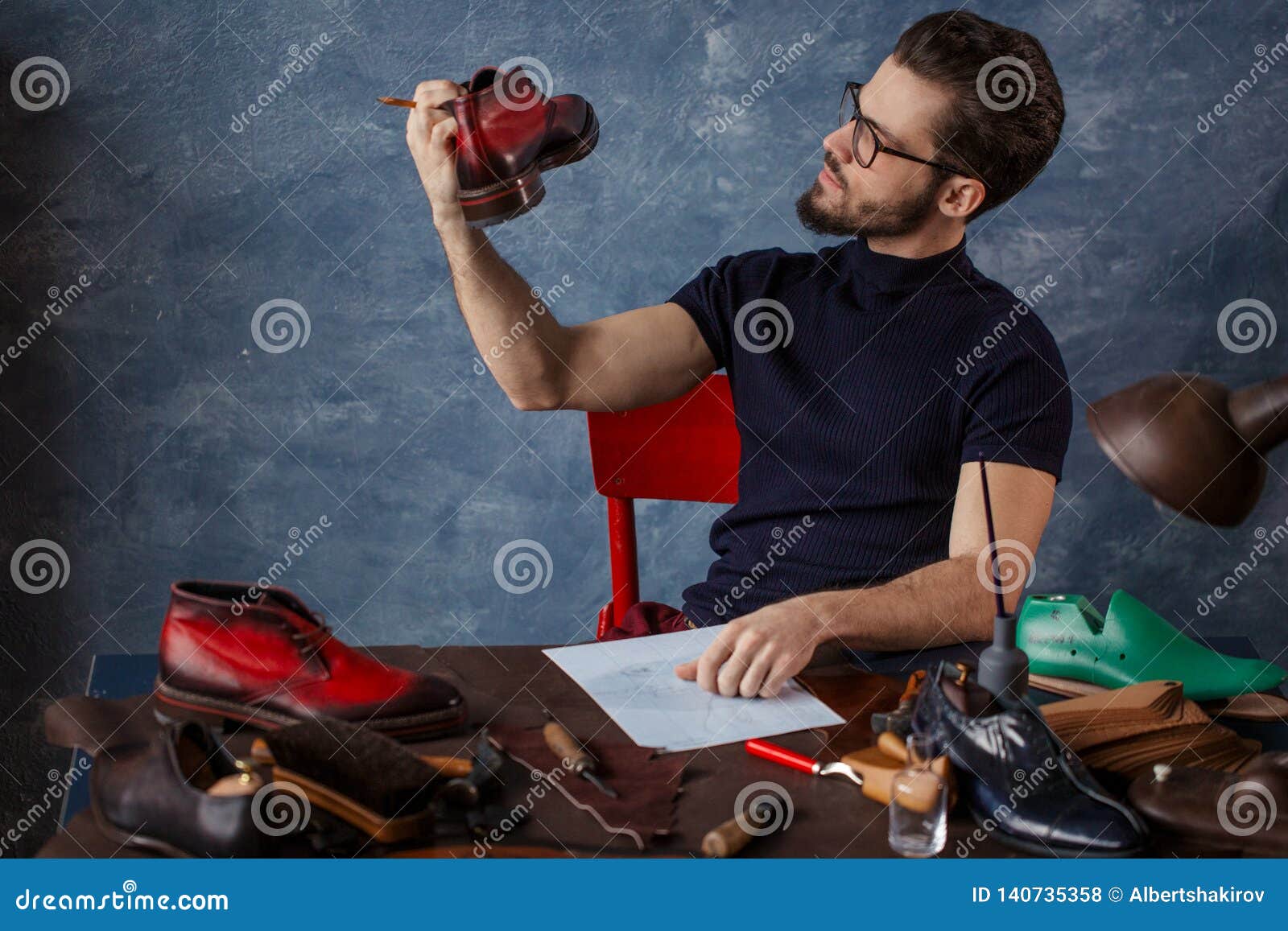Young Shoemaker Exploring a Painted Boot Stock Photo - Image of maker ...
