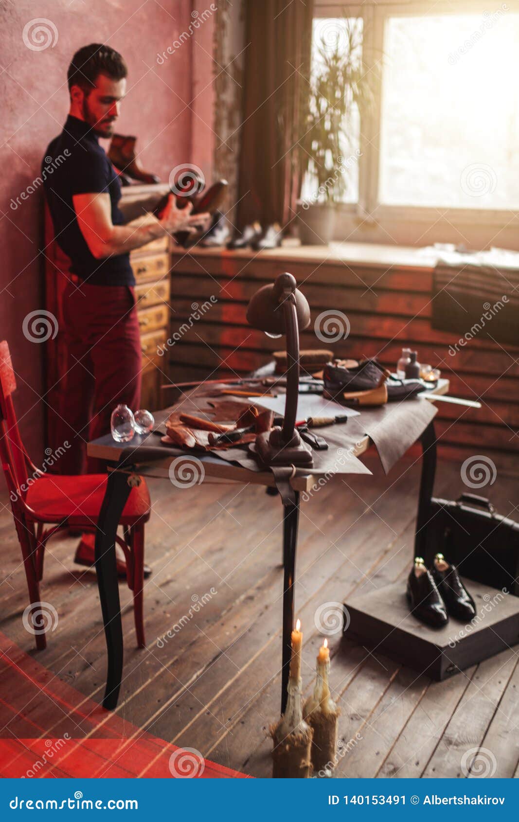 Young Shoemaker Standing Near the Desk with Useful Tools in Workshop ...