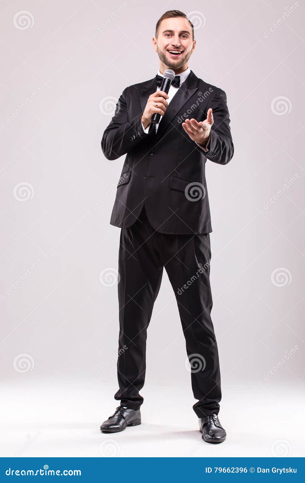 Young Showman Presenter with Microphone Against White Background. Stock ...