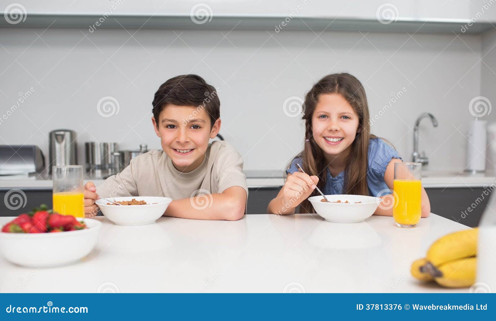 Young Siblings Enjoying Breakfast in Kitchen Stock Photo - Image of ...