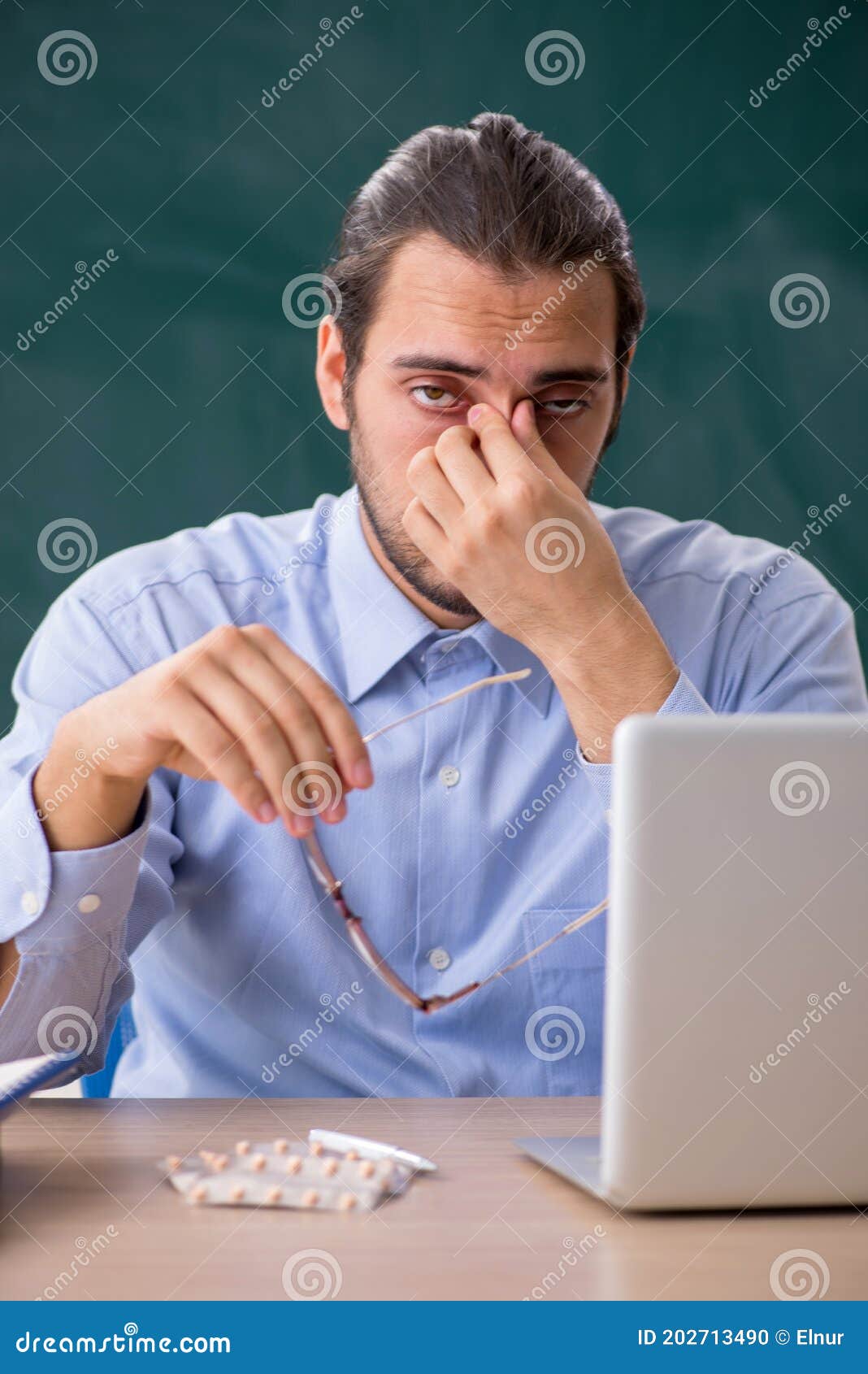 Young Sick Male Teacher in the Classroom Stock Photo - Image of sick ...