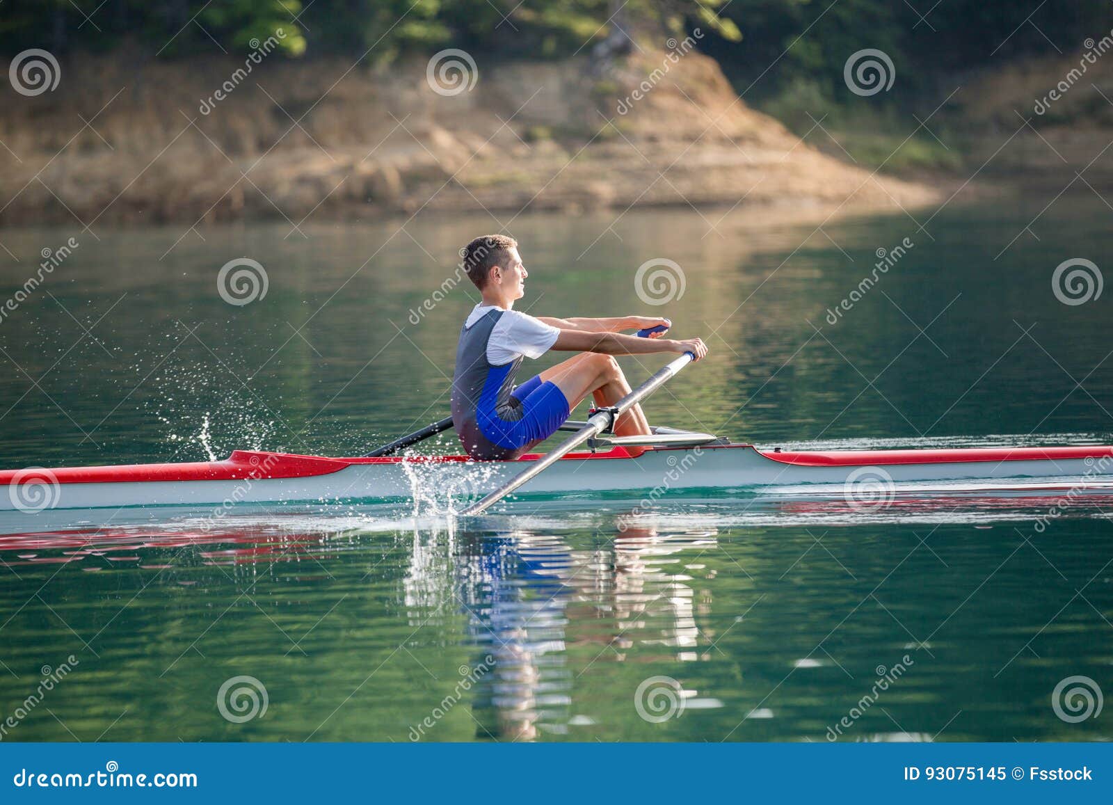 A Young Single Scull Rowing Competitor Paddles on the Tranquil Lake ...