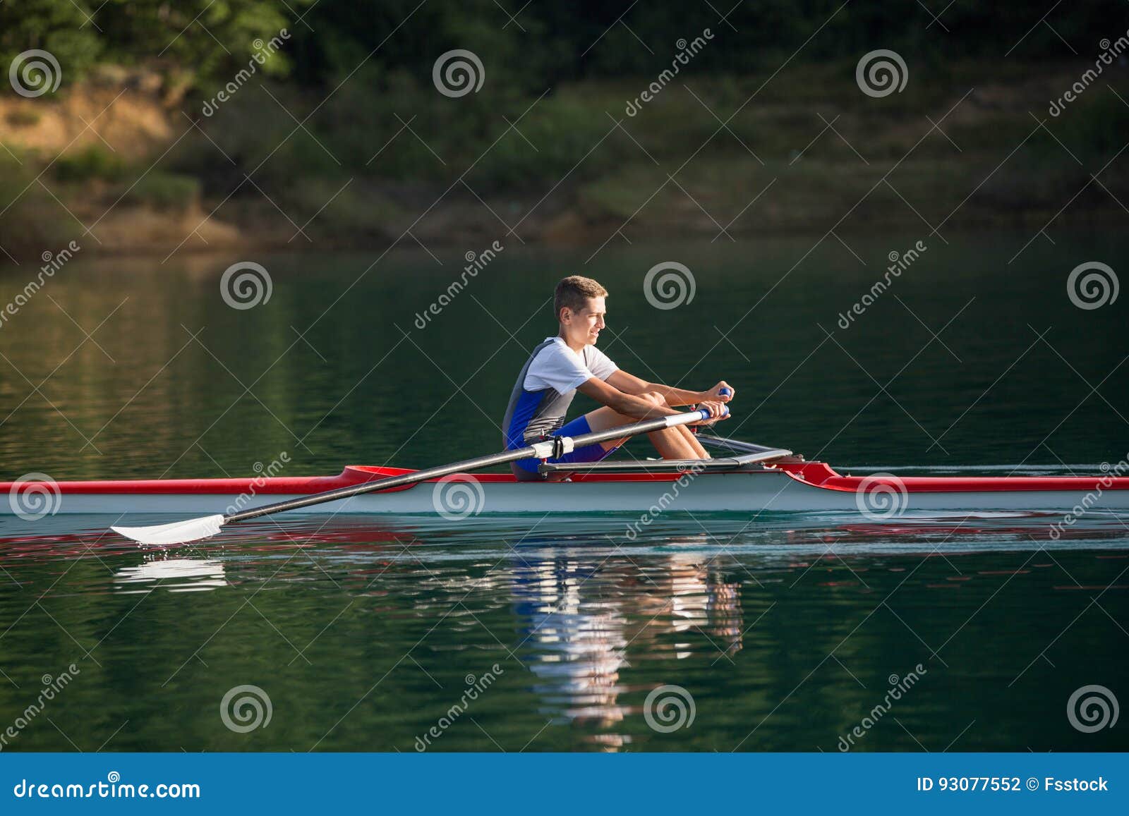 A Young Single Scull Rowing Competitor Paddles on the Tranquil Lake ...