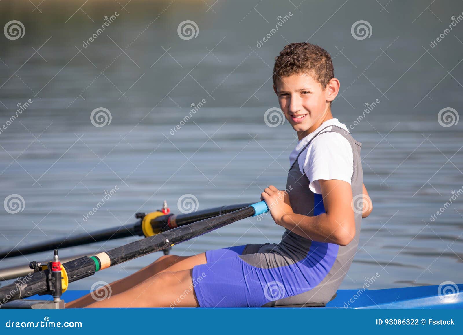 A Young Single Scull Rowing Competitor Paddles on the Tranquil Lake ...