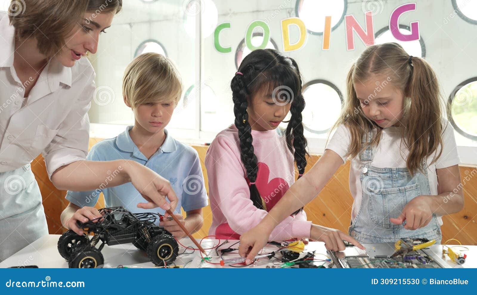 Young Smart Teacher Teaching Diverse Students about Electronic Board ...