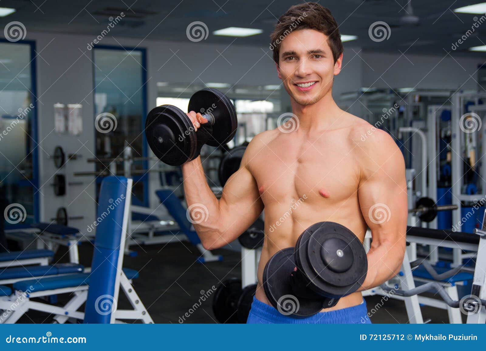 Young Smiling Athlete Lifting Weights in the Gym Stock Photo - Image of ...