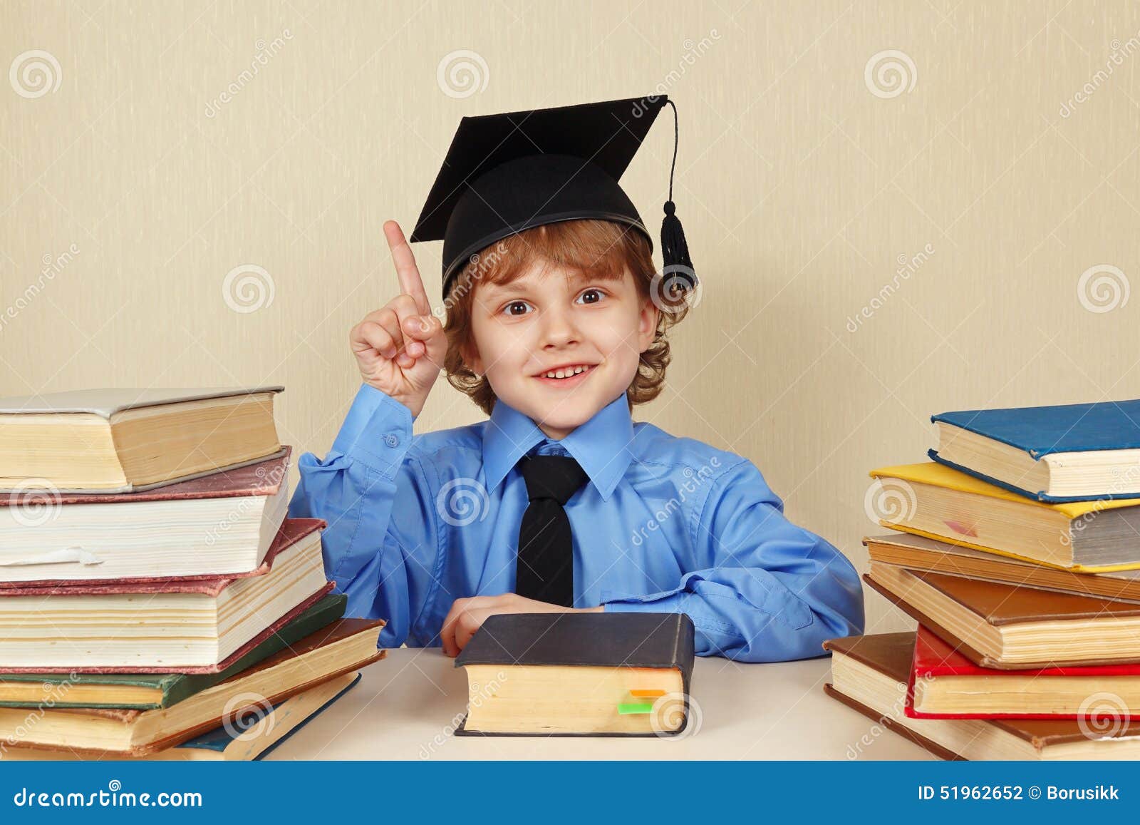 Young Smiling Boy in Academic Hat among Old Books Stock Photo - Image ...