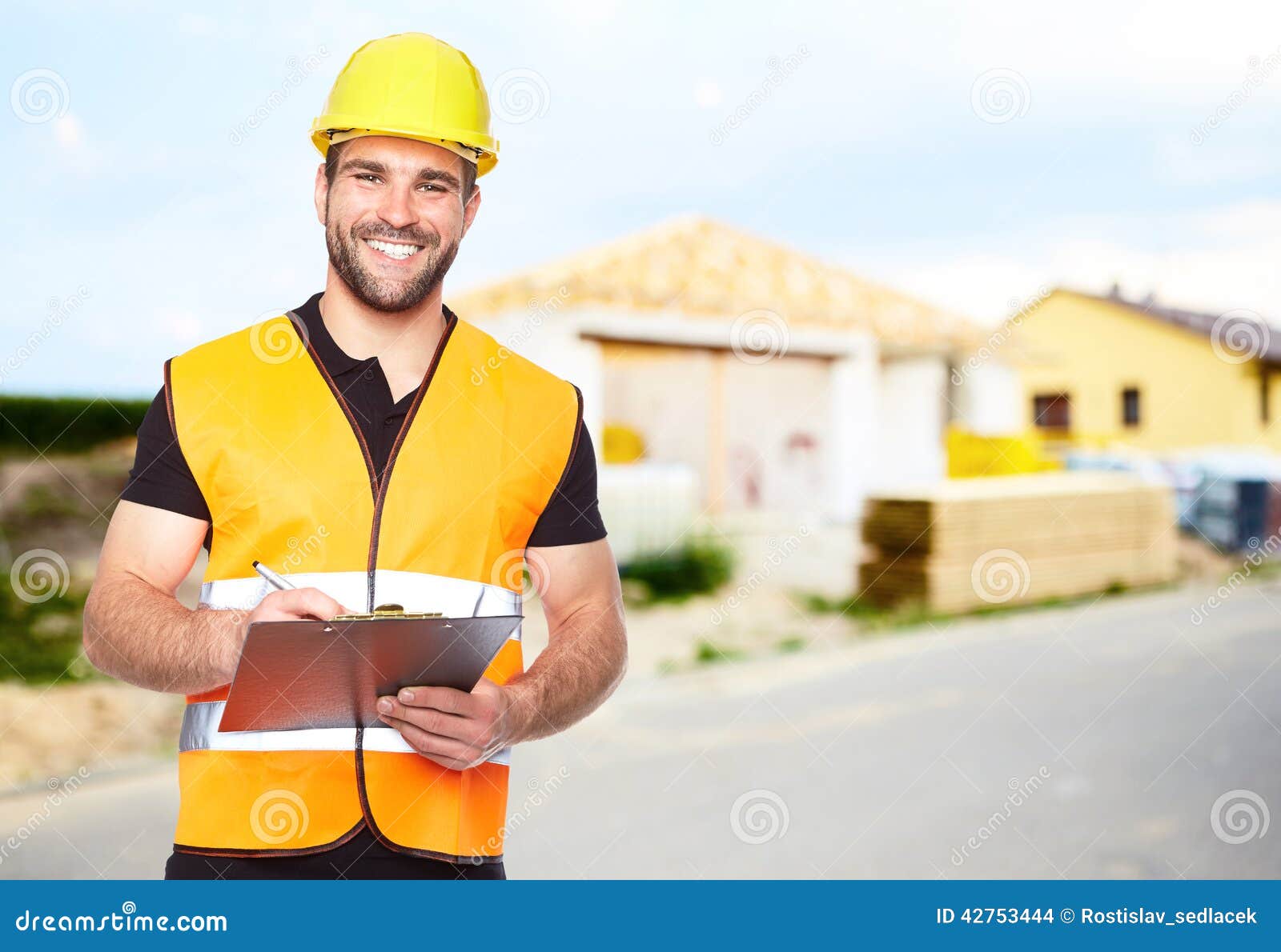 Young Smiling Builder Writes on a Black Folder Stock Photo - Image of ...
