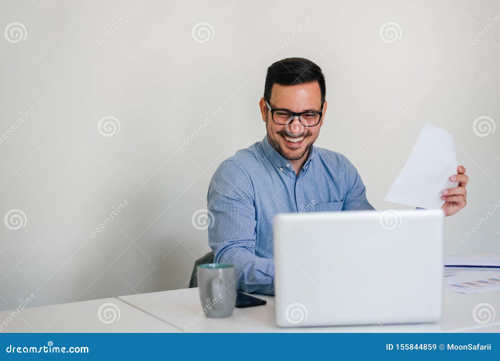 Young Smiling Cheerful Businessman in Office Working with Laptop ...
