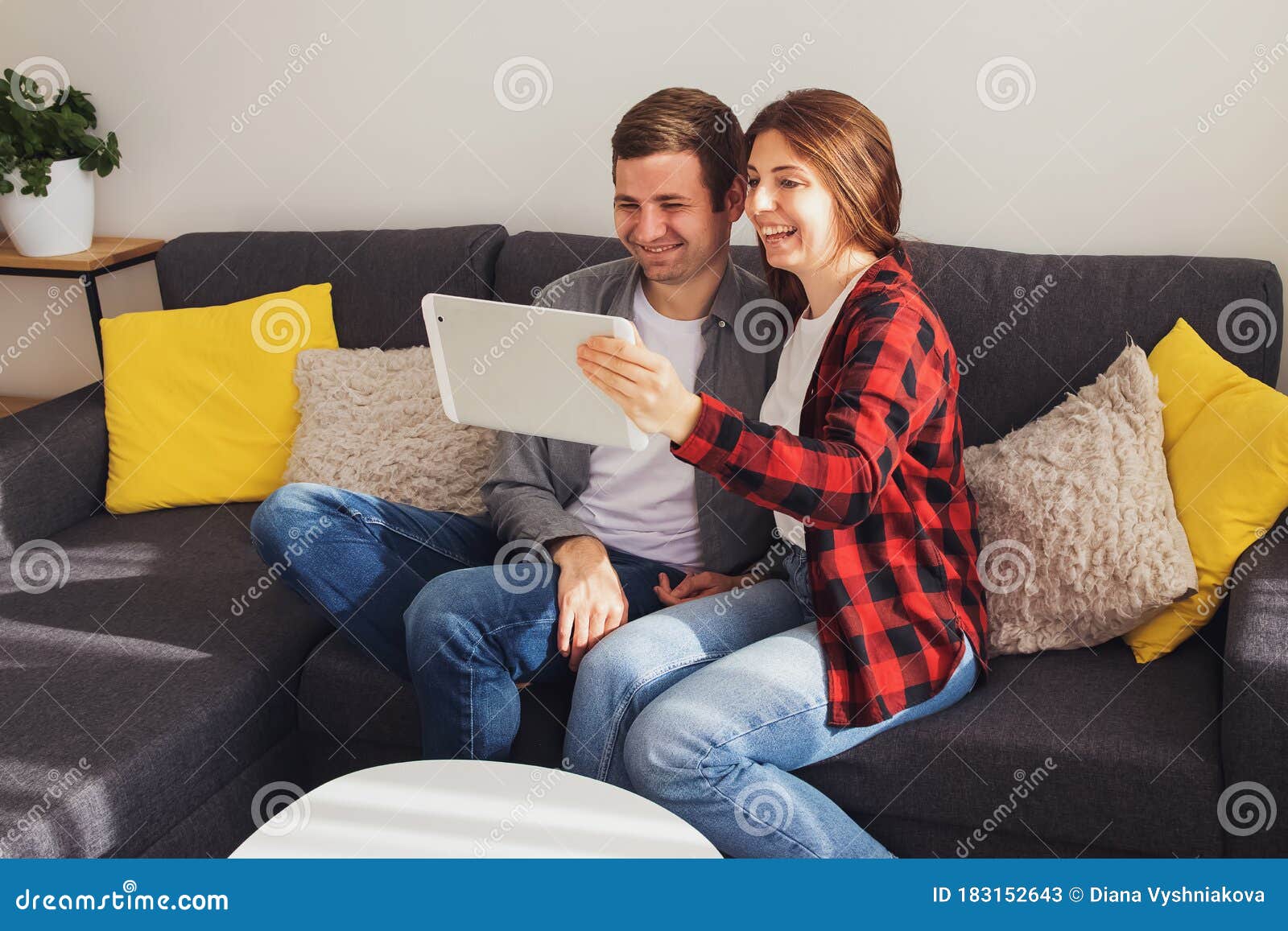 Young Smiling Couple Making Video Call Using Digital Tablet Stock Image ...