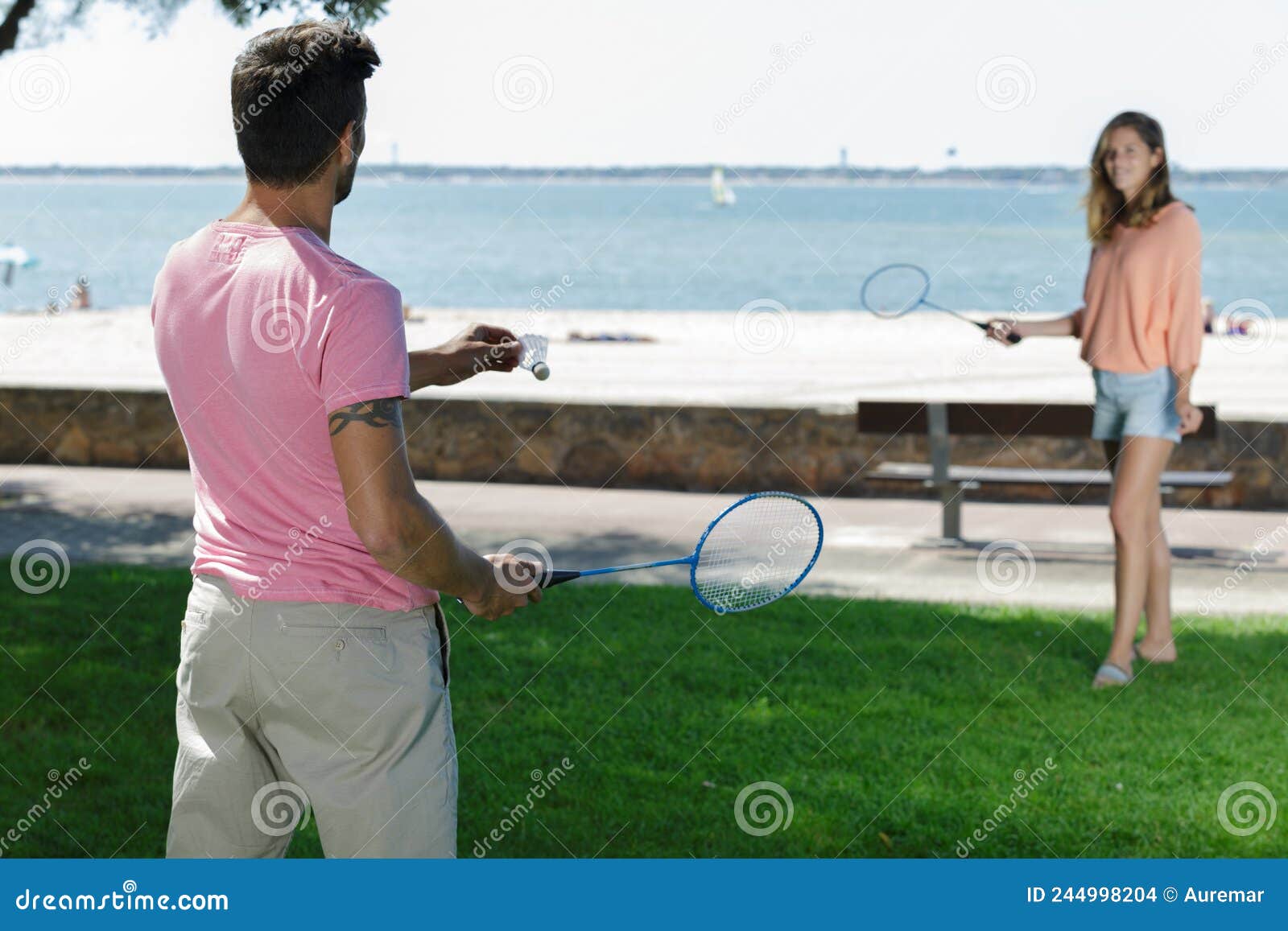 Young Smiling Couple Playing Badminton Stock Photo - Image of cute ...