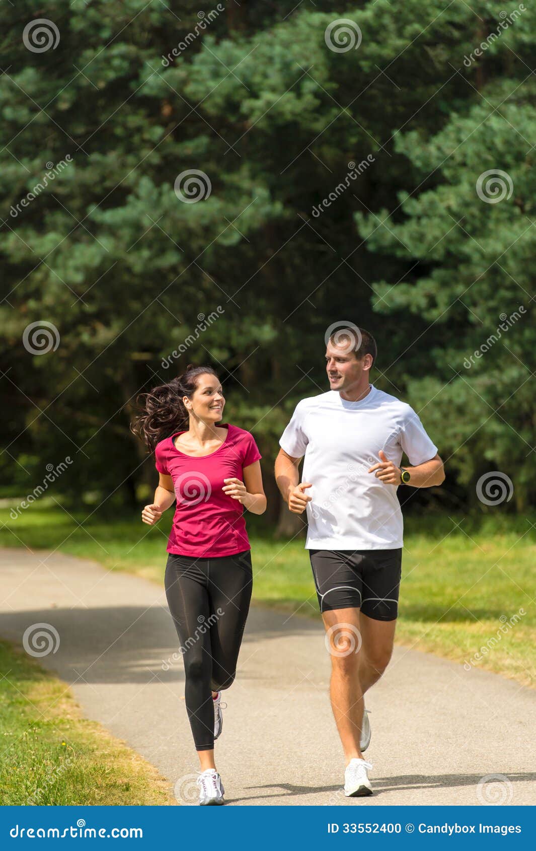 Young Smiling Couple Running in Park Stock Photo - Image of runners ...