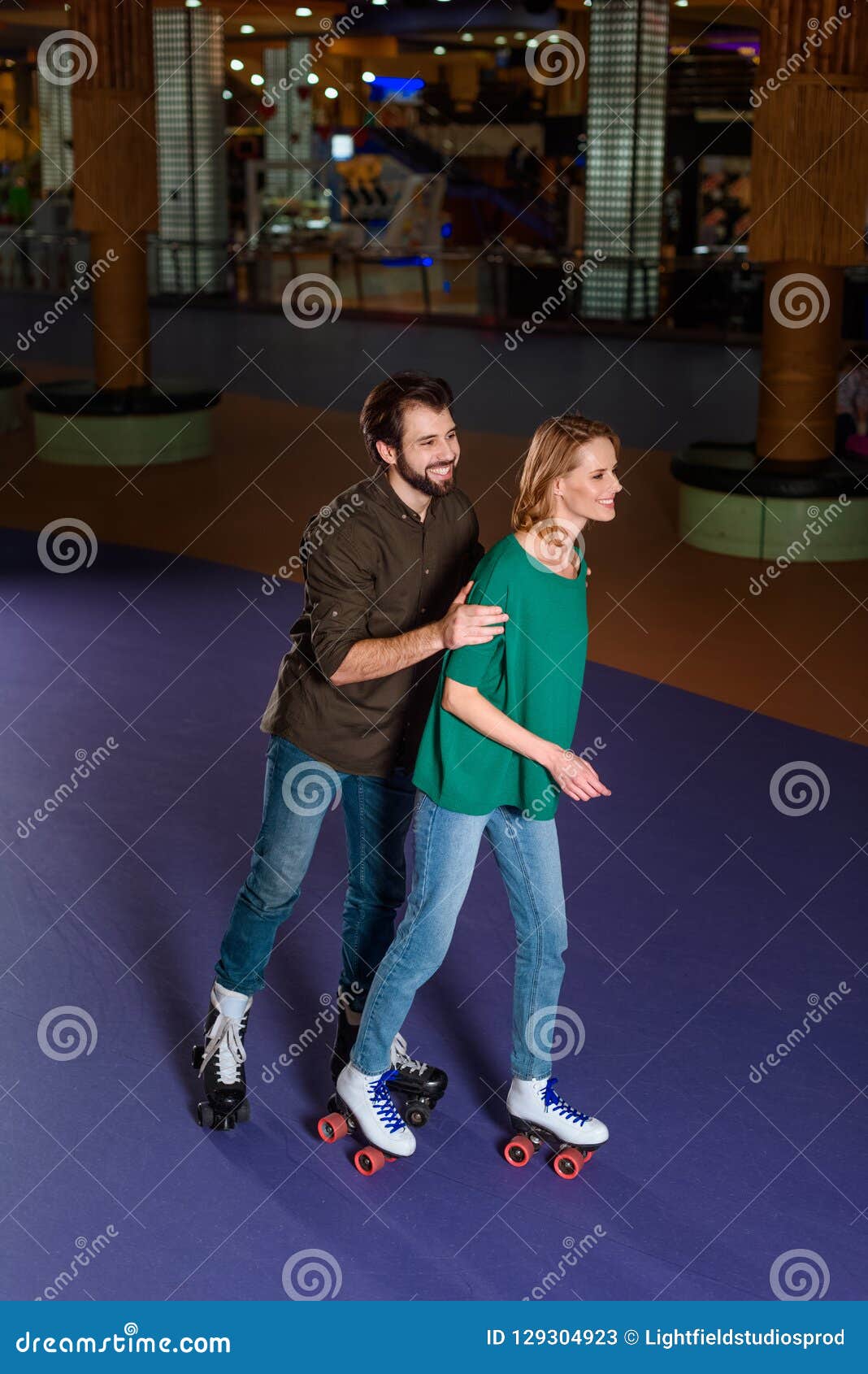Young Smiling Couple Skating Together Stock Image - Image of ...