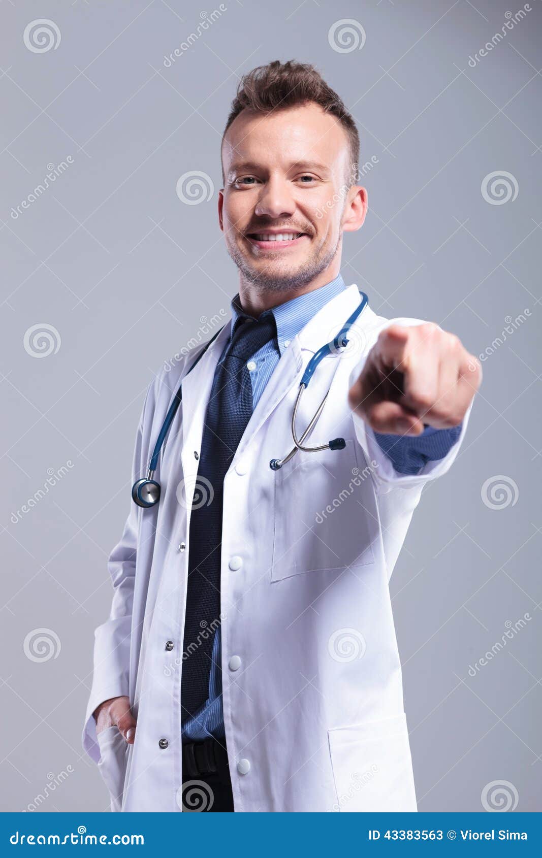 Young Smiling Doctor Pointing Finger Stock Image - Image of arms ...