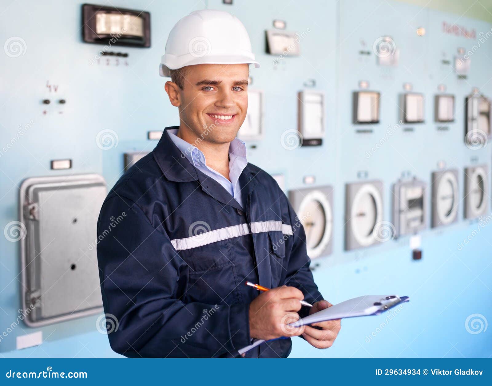 Young Smiling Engineer Taking Notes at Control Room Stock Photo - Image ...