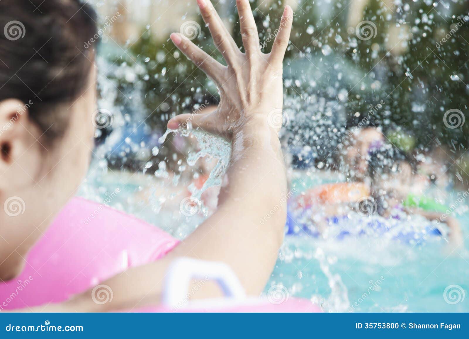 Young Smiling Family Splashing and Playing in the Pool Stock Photo ...