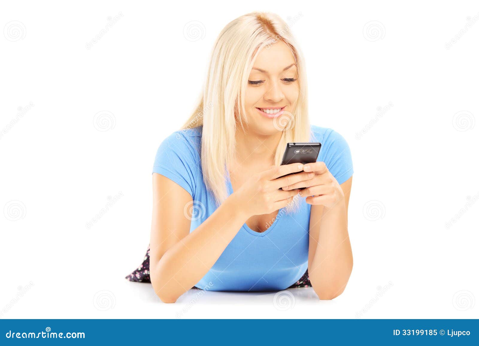 Young Smiling Female Lying Down And Using Her Phone Royalty Free Stock ...
