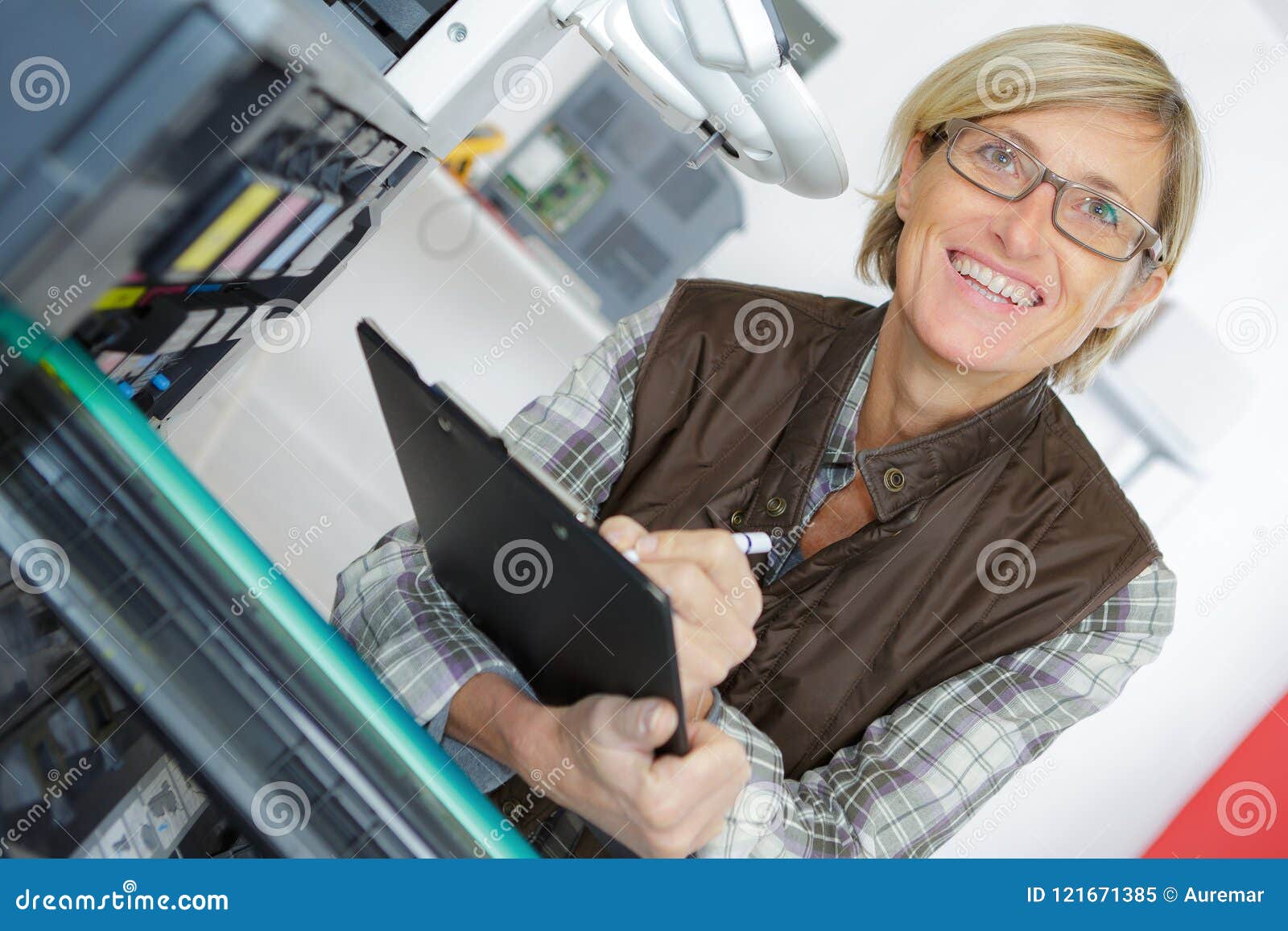 Young Smiling Female Technician in Overalls Holding Clipboard Stock ... Young Smiling Female Technician in Overalls Holding Clipboard Stock ...