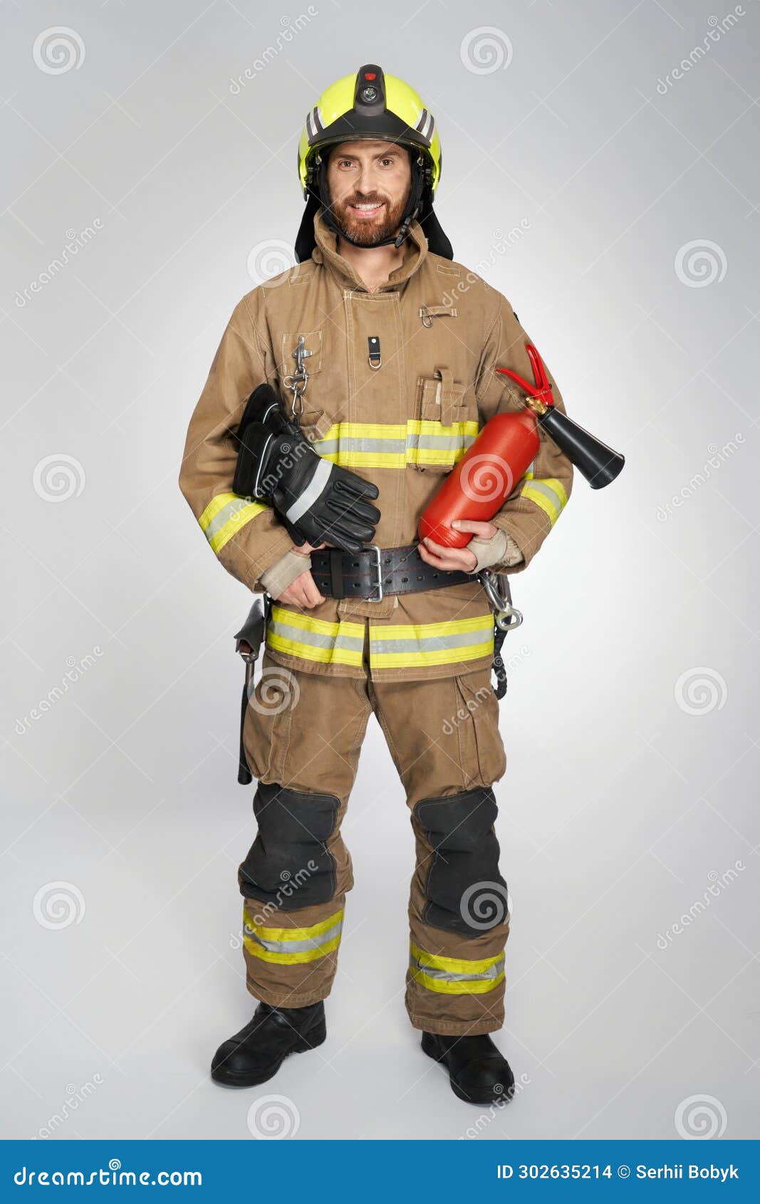 Young, Smiling Firefighter with Fire Extinguisher in Studio. Stock ...