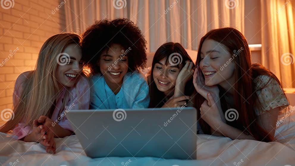 Young Smiling Girlfriends Watching Laptop On Bed Stock Image Image Of