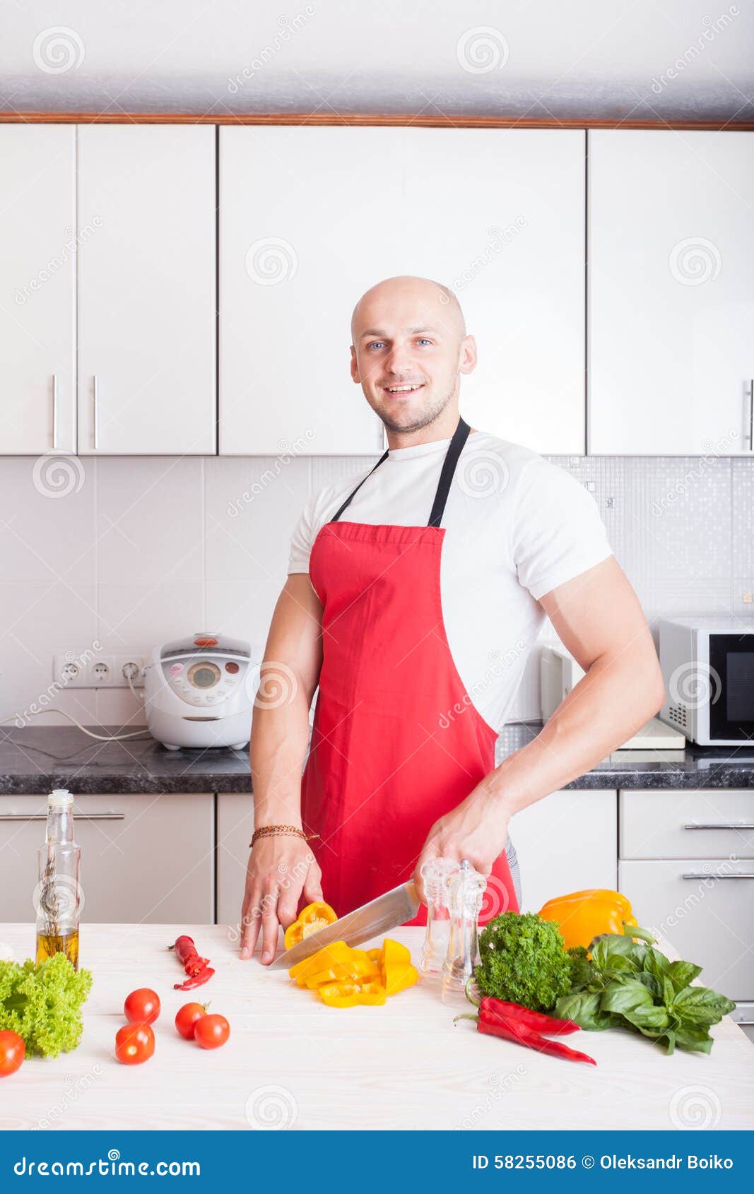Young smiling man cooking stock photo. Image of loosing - 58255086