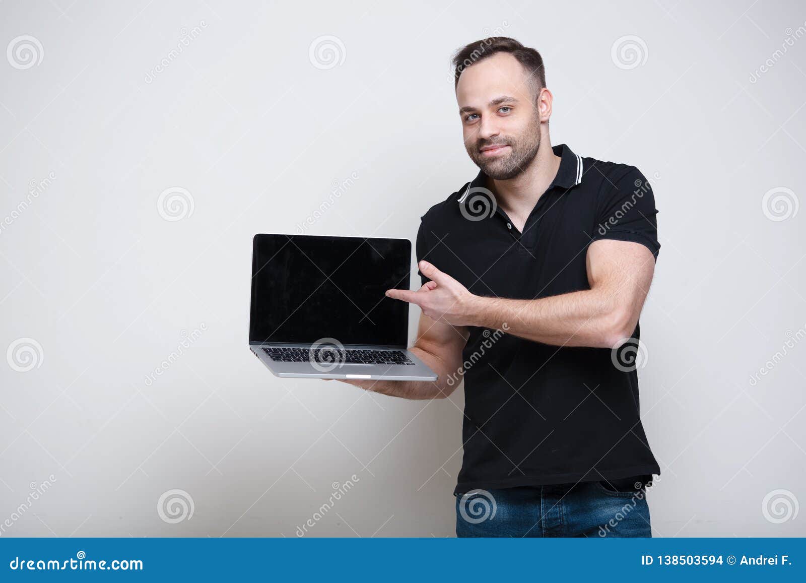 Young Smiling Man Pointing on Laptop Over White Background Stock Photo ...