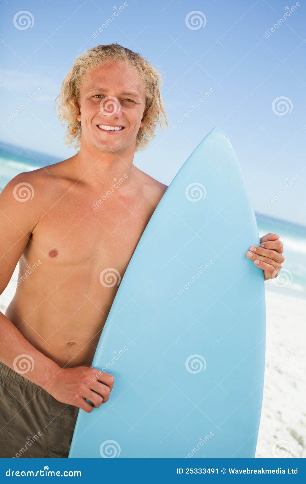 Young Smiling Man Standing Upright while Holding His Perched Surfboard ...