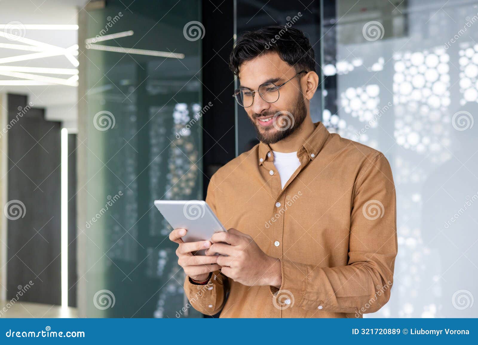 Young Smiling Muslim Male Programmer and Designer Standing in Modern ...