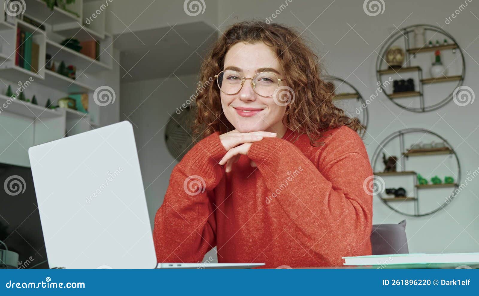 Young Smiling Pretty Woman Student Sitting at Table at Home Office with ... Young Smiling Pretty Woman Student Sitting at Table at Home Office with ...