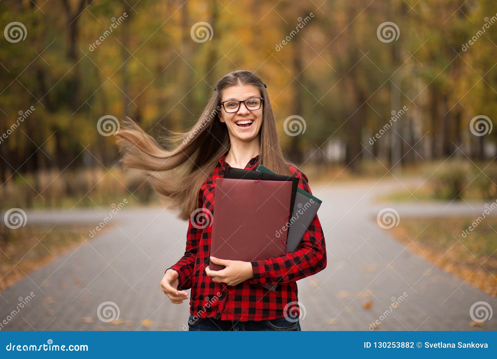 Young Smiling Student Woman with Folders. Knowledge Concept Stock Photo ... Young Smiling Student Woman with Folders. Knowledge Concept Stock Photo ...