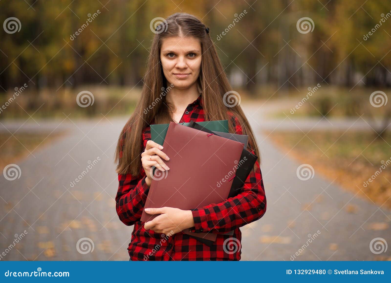 Young Smiling Student Woman with Folders. Education Concept Stock Photo ... Young Smiling Student Woman with Folders. Education Concept Stock Photo ...